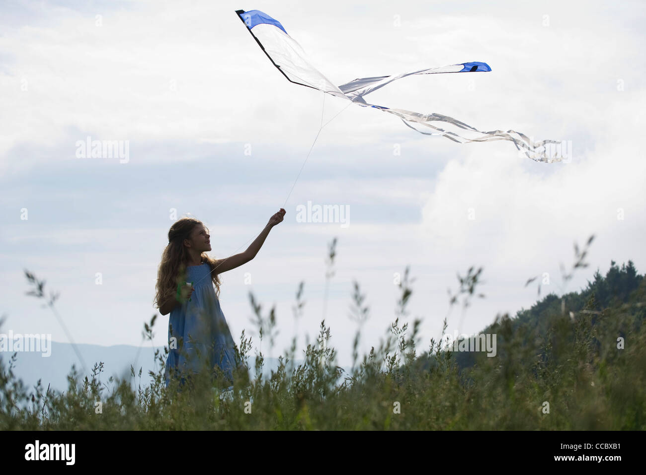 Girl flying kite Stock Photo - Alamy