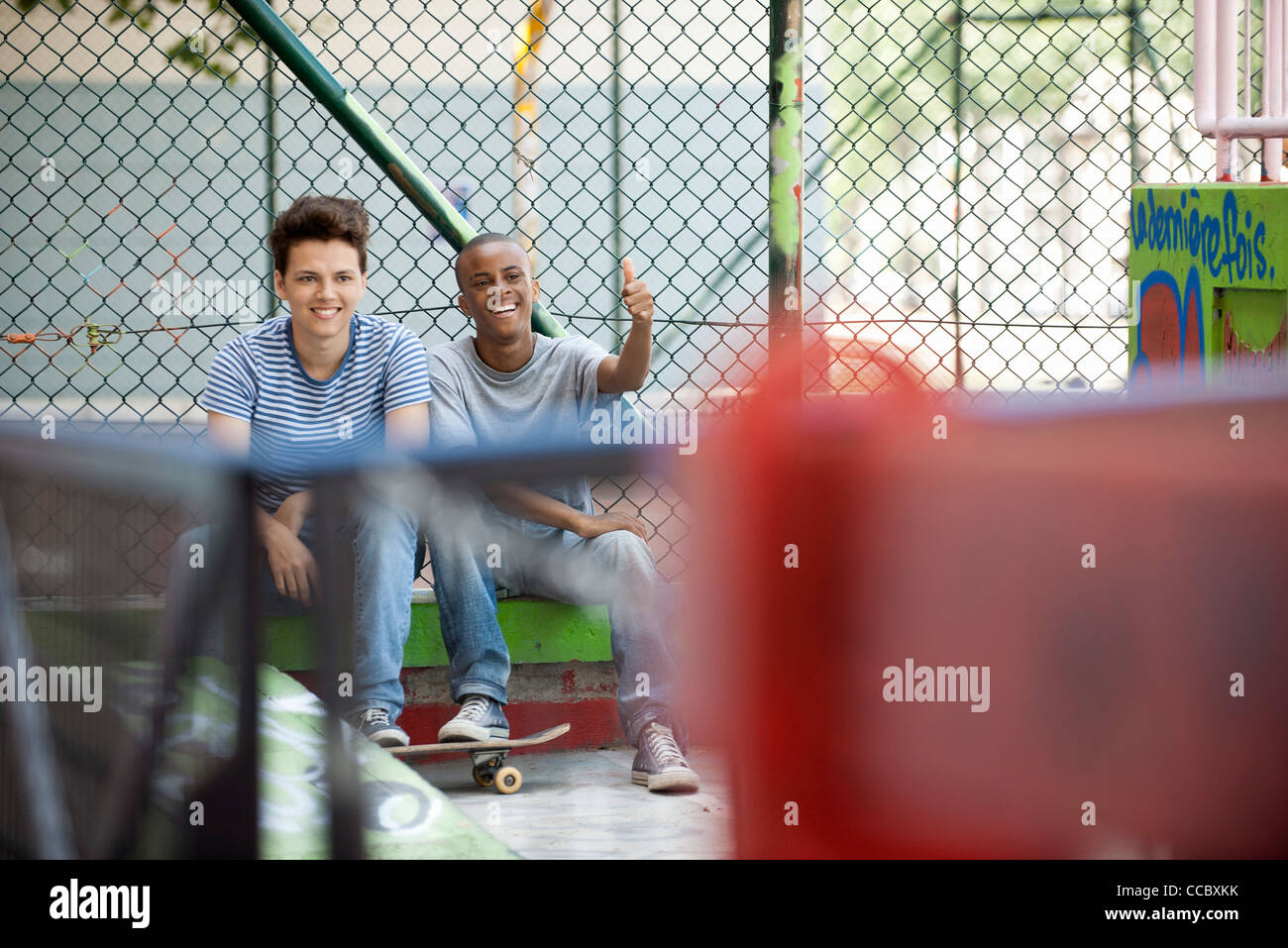 Young men hanging out in skateboard park Stock Photo - Alamy