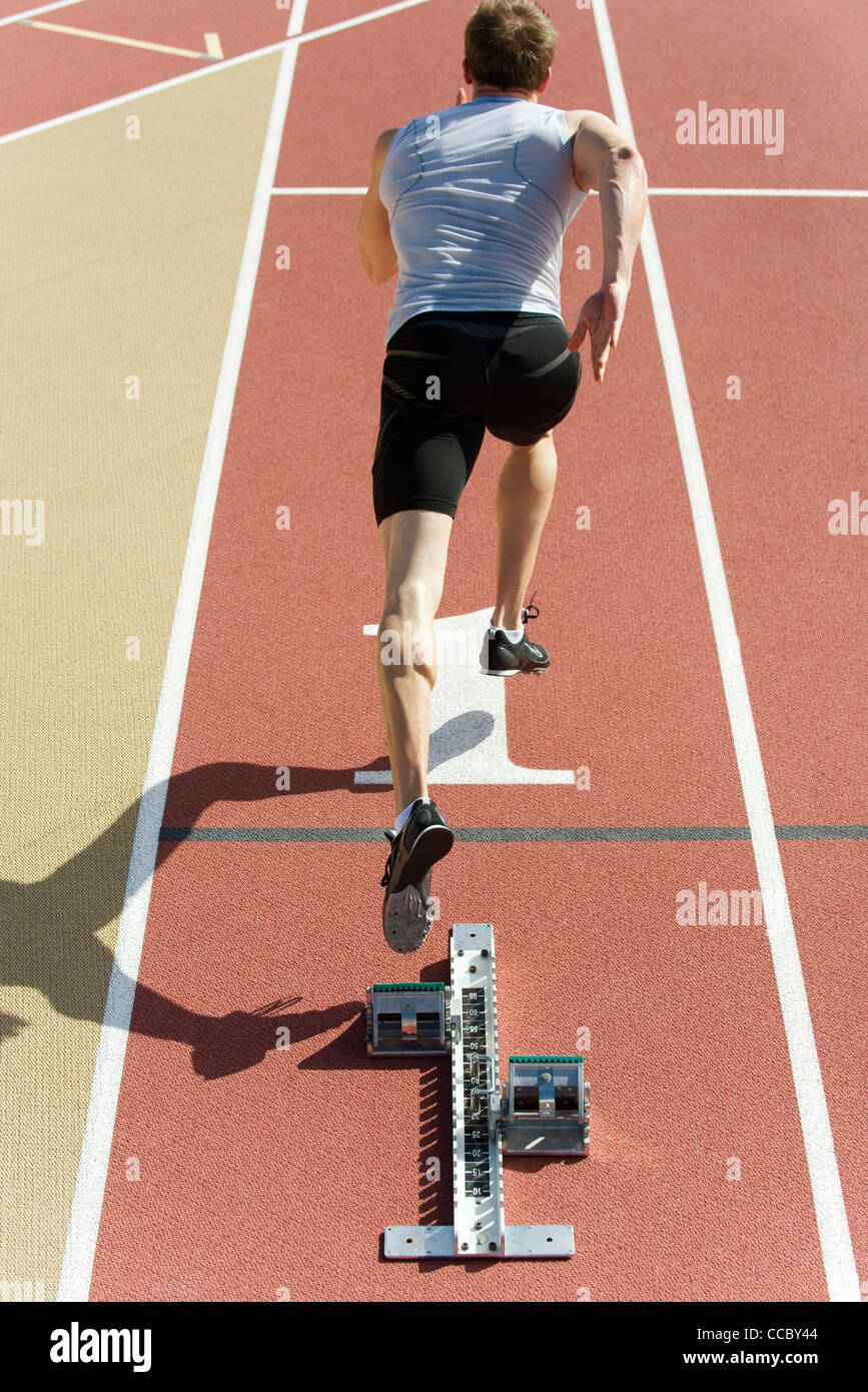 Man running on track, rear view Stock Photo - Alamy
