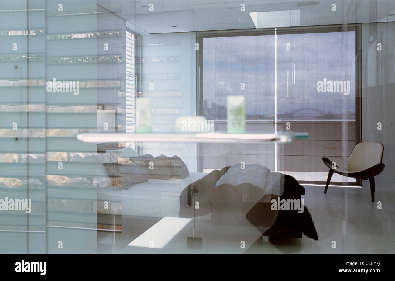 PRIVATE HOUSE VIEW THROUGH GLASS WALL OF EN-SUITE TO BEDROOM Stock ...