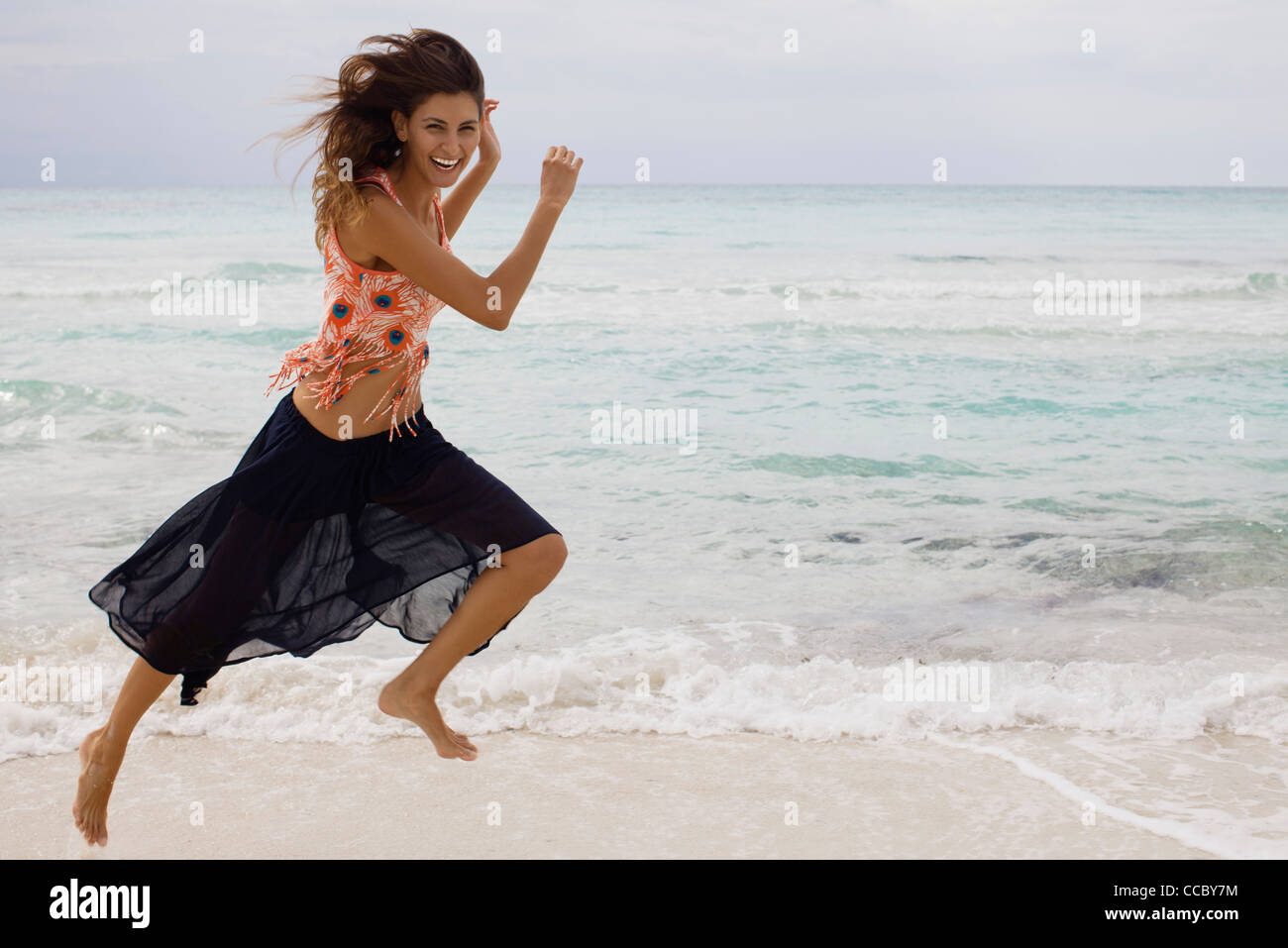 Woman running at the beach Stock Photo - Alamy
