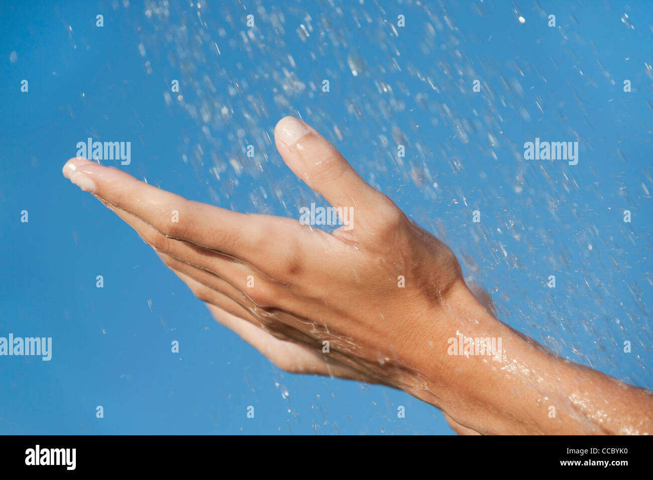 Hands under splashing water Stock Photo - Alamy