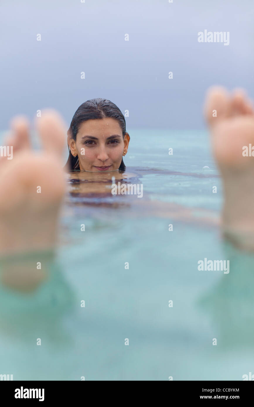 Woman floating in water, portrait Stock Photo - Alamy