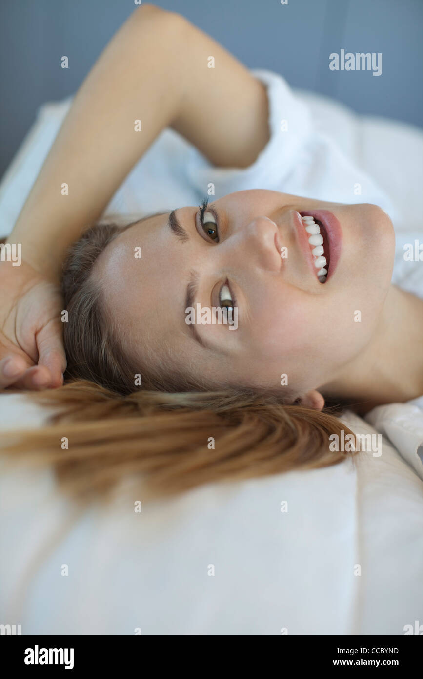 Young woman lying down, portrait Stock Photo - Alamy