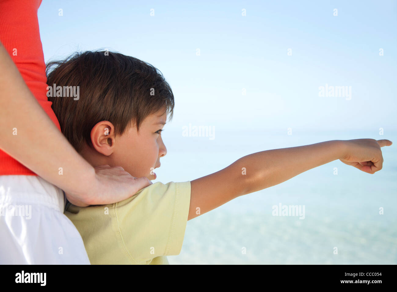 Boy pointing at sea Stock Photo - Alamy