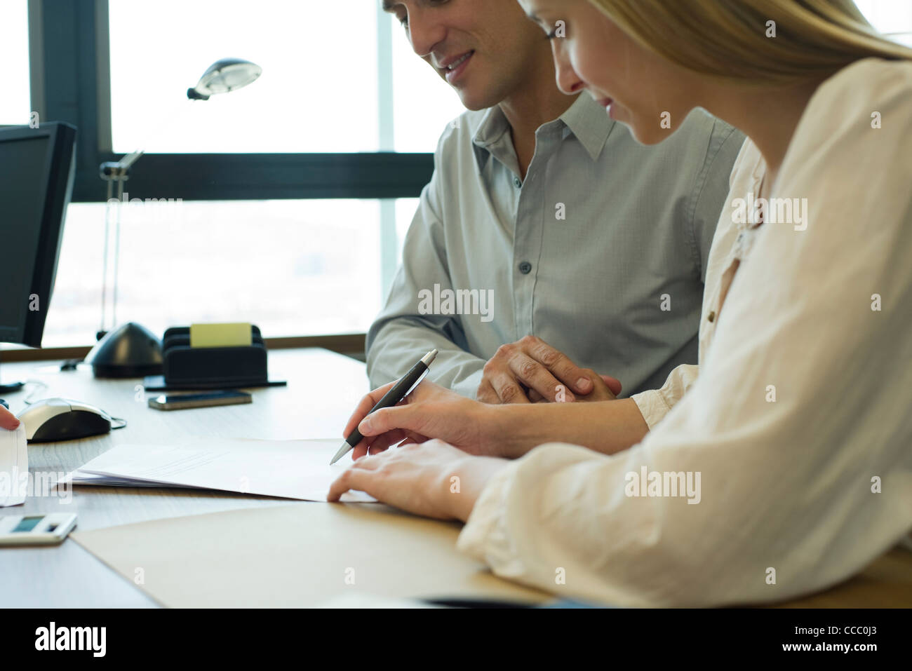 Couple signing contract Stock Photo - Alamy