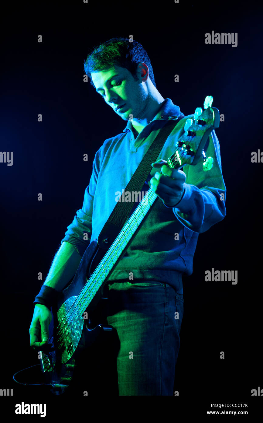 Man Playing Electric Bass on Black Background Stock Photo - Alamy