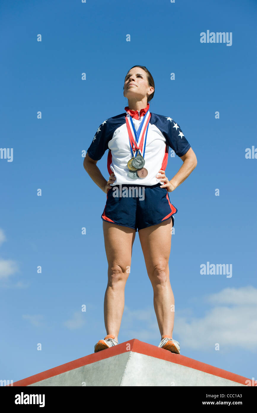 Female athlete standing on winner's podium Stock Photo - Alamy