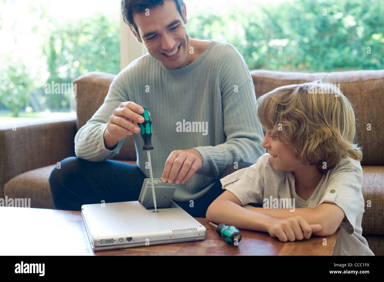 Father son fixing table hi-res stock photography and images - Alamy