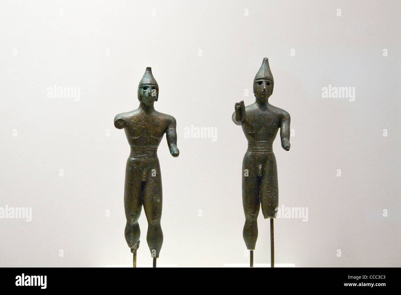 Bronze warrior statuettes with conical helmets and belts, rendered by ...