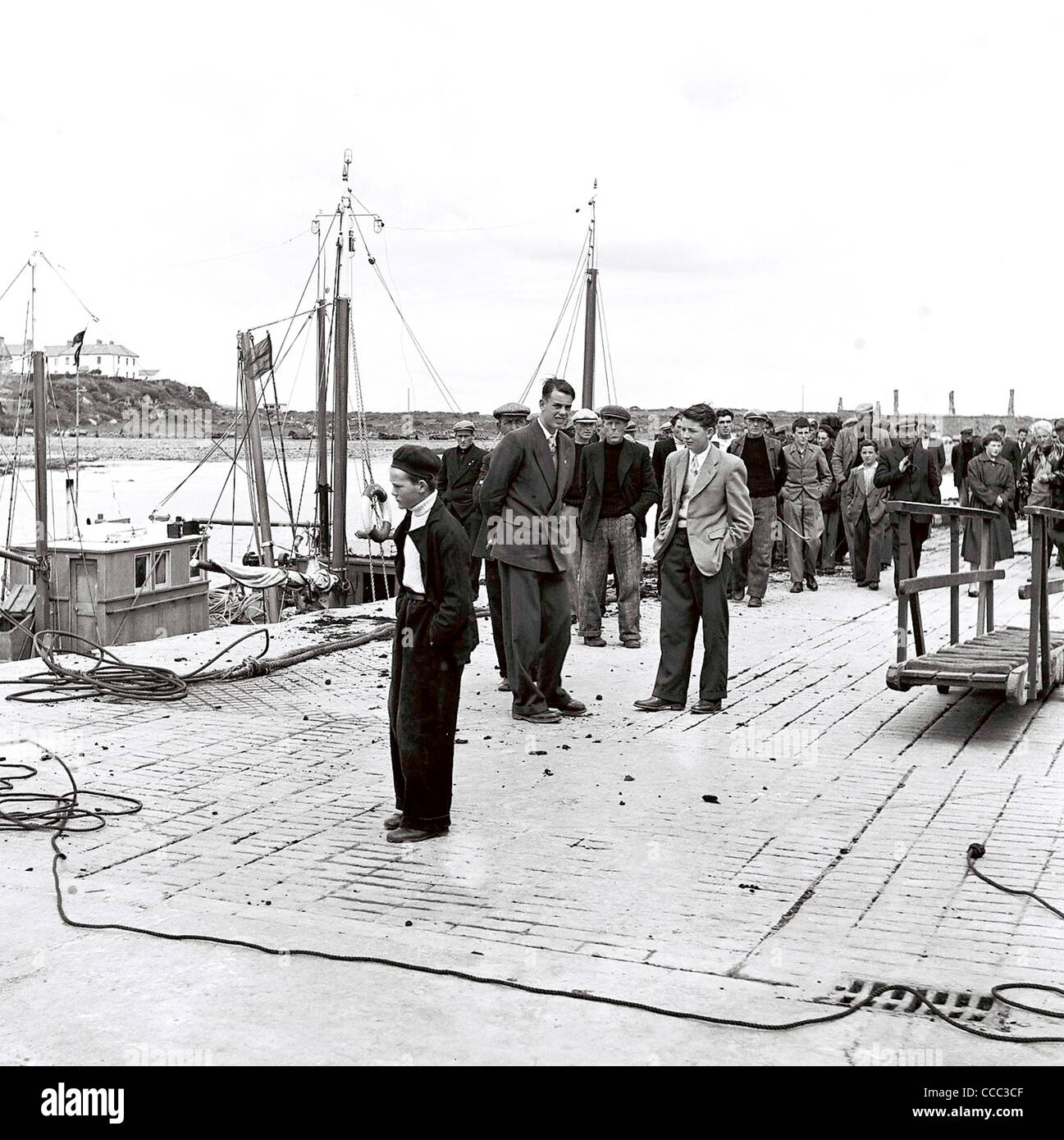 Islanders and visitors mingle on the pier at Kilronan Inis Mor Aran ...