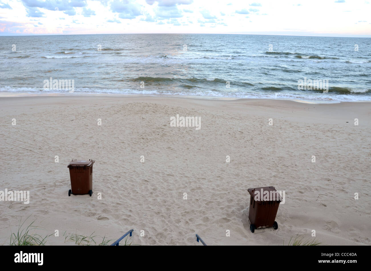 Garbage containers in sea sand. Sea waves. Natural seashore backdrop ...