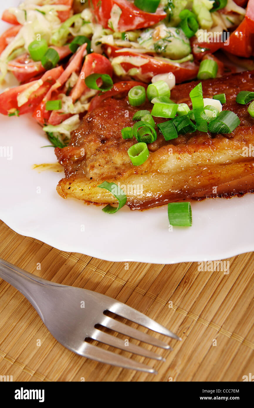 Fried meat with vegetable garnish Stock Photo - Alamy