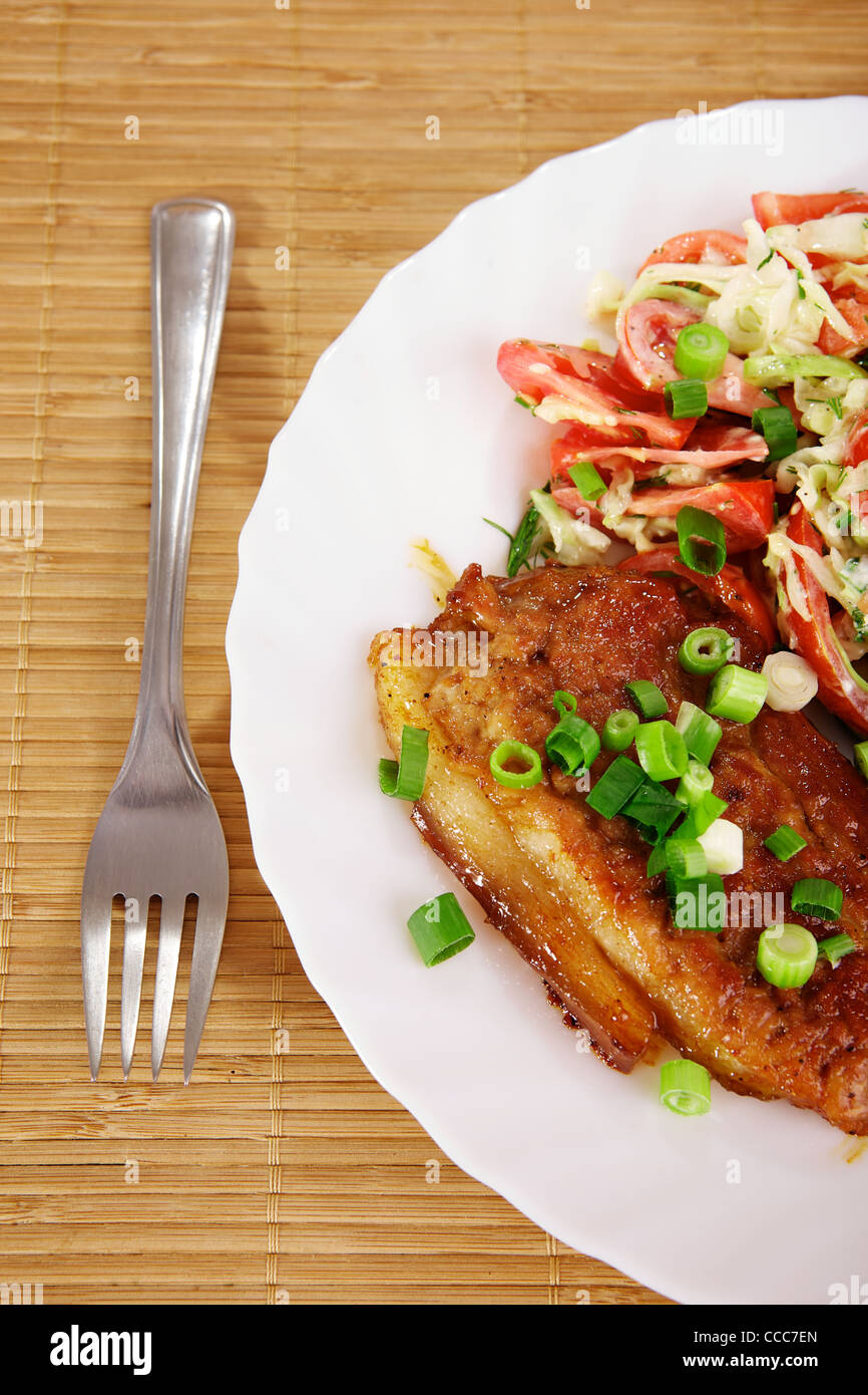 Fried meat with vegetable garnish Stock Photo - Alamy