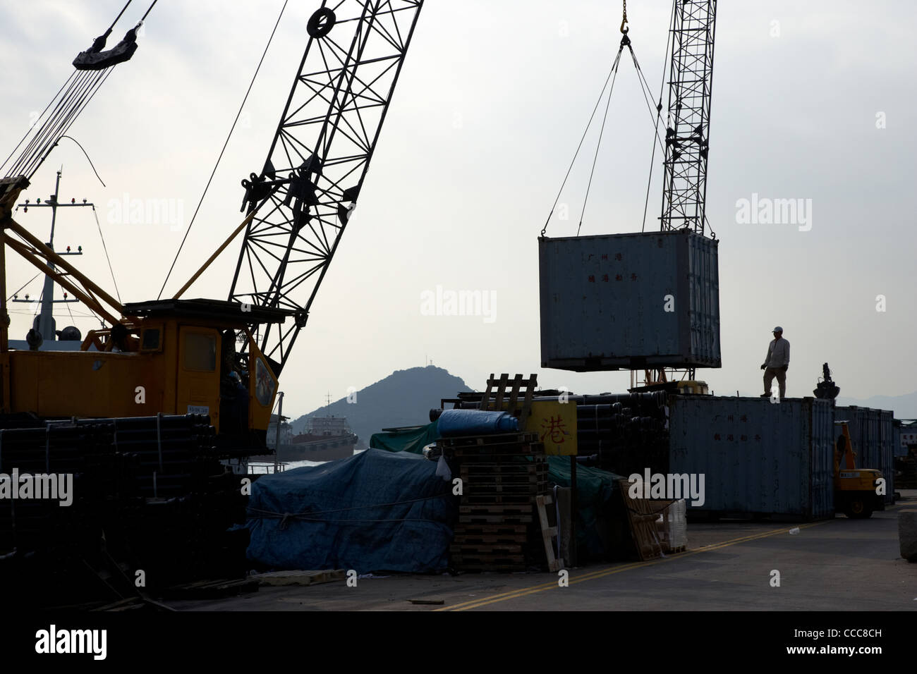 crane unloading cargo in small pier in western district hong kong hksar ...