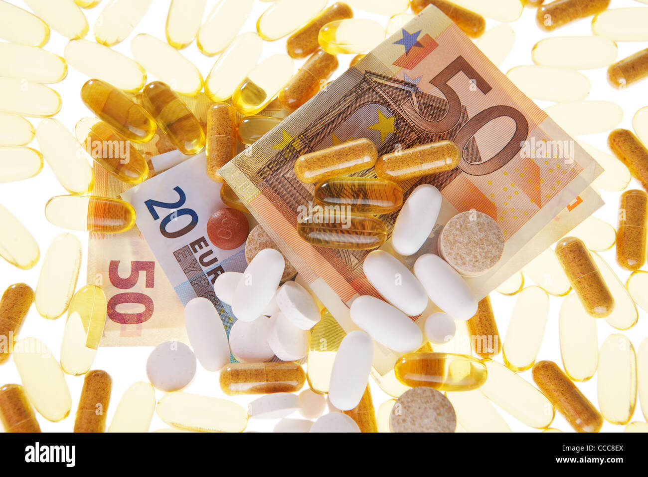 Pills and the euro on a white background Stock Photo - Alamy