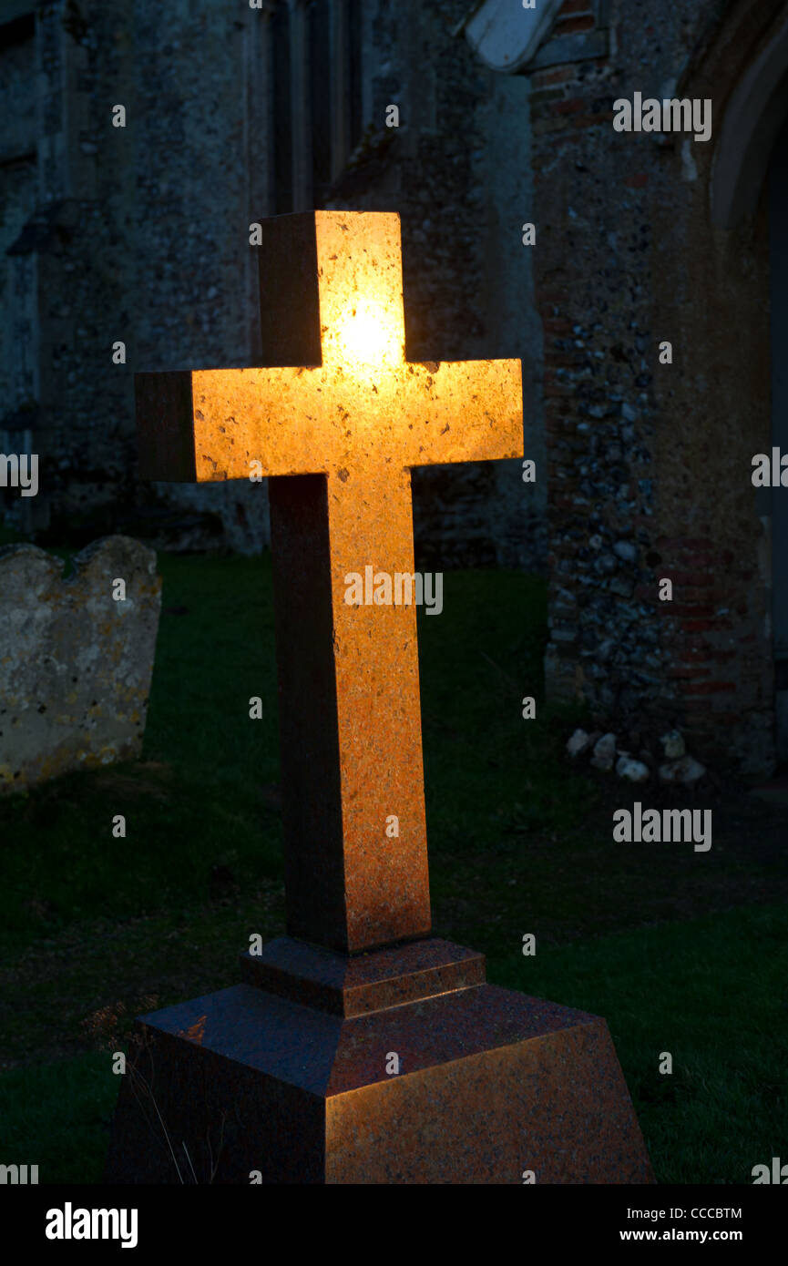Stone cross or crucifix with evening sun shining on it Gives Gothic ...