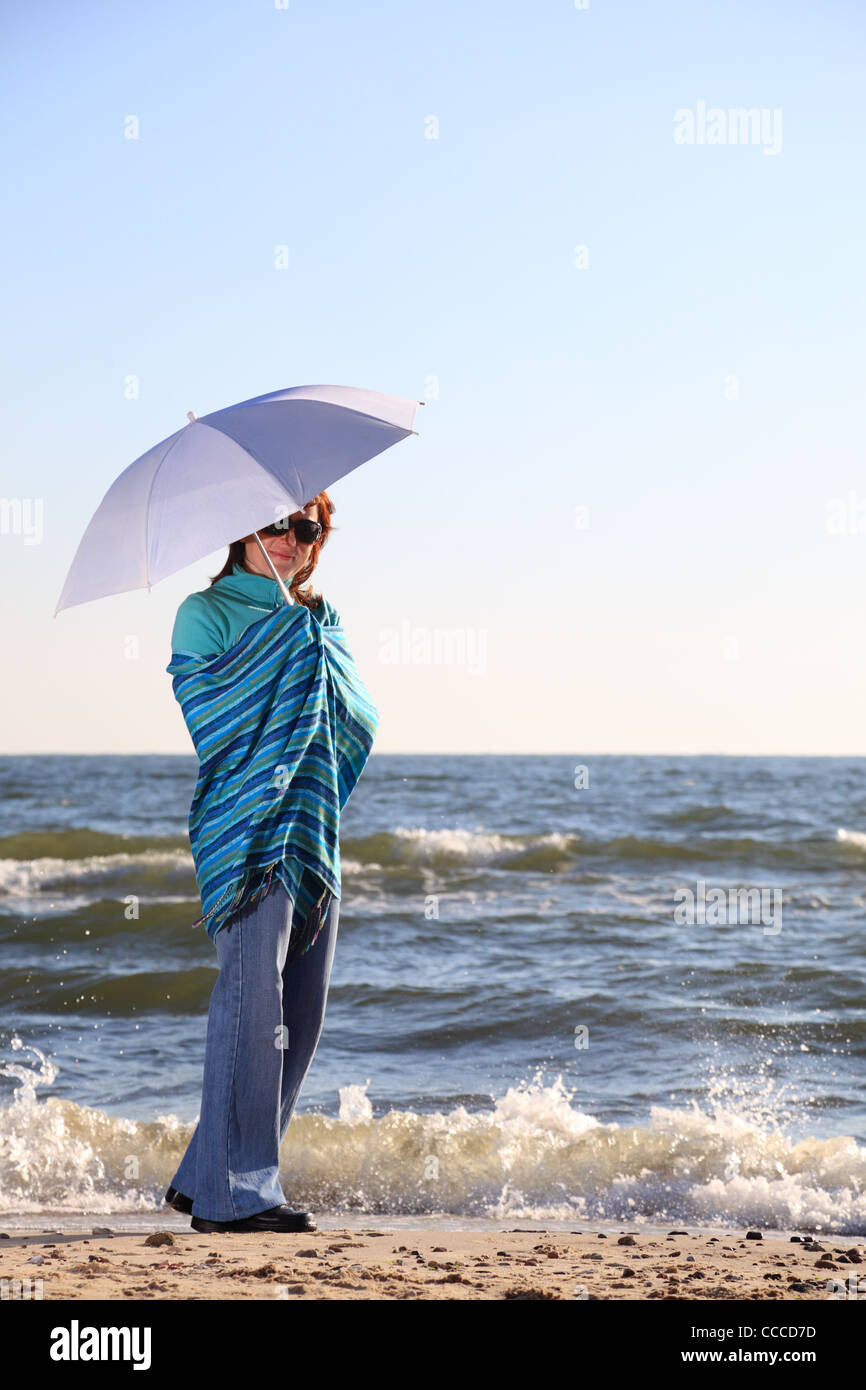 blue woman and parasol at sea shore Stock Photo - Alamy