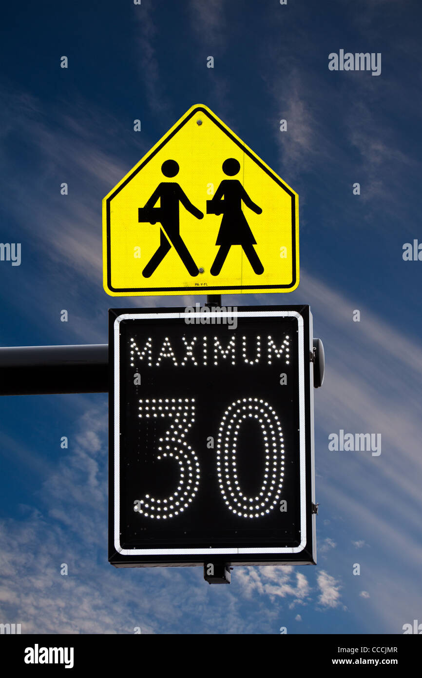 An electric 30km/h speed limit sign, under a sign who indicate the ...