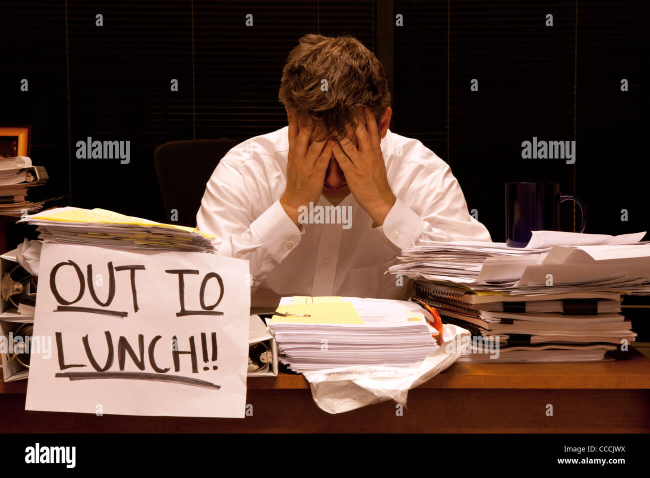 Stressed out office with piles of paperwork Stock Photo - Alamy