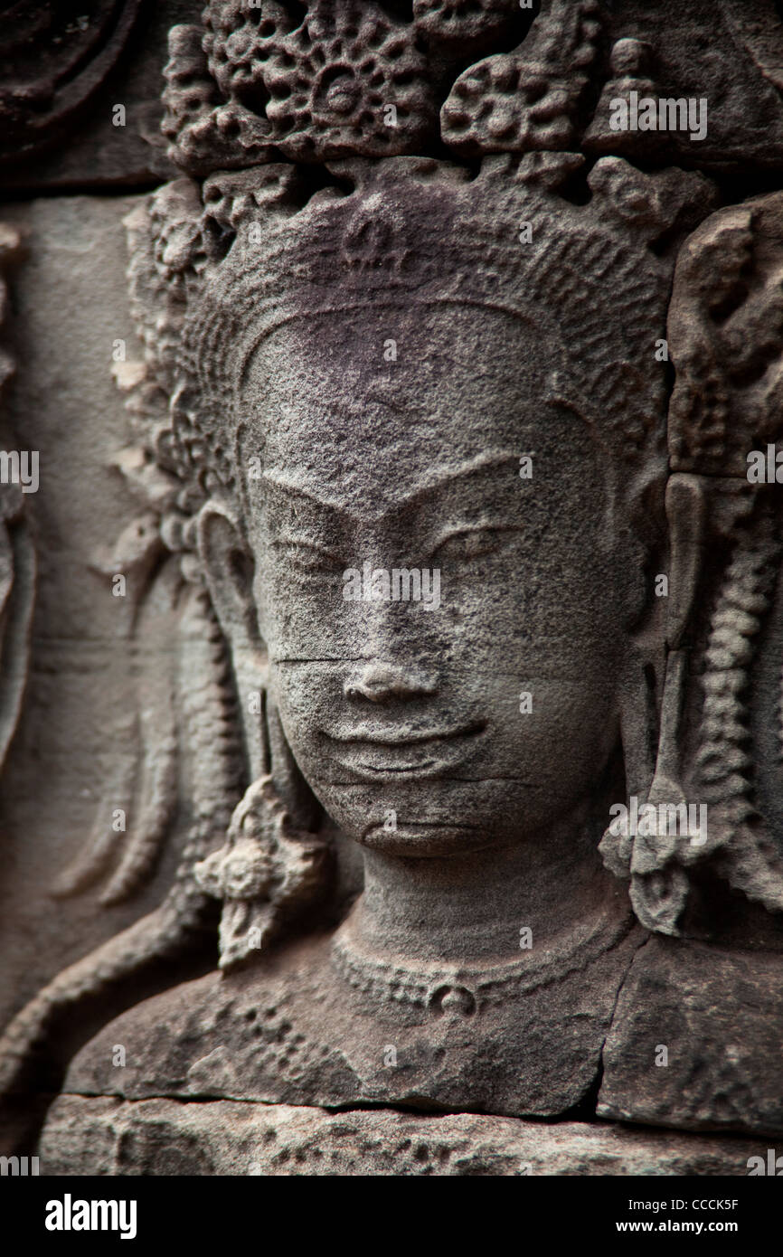 Woman smiling, close-up of bas-reliefs and decorations, Bayon temple ...