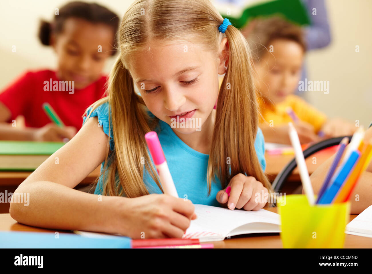 Portrait of lovely girl drawing with colorful pencils at lesson Stock ...