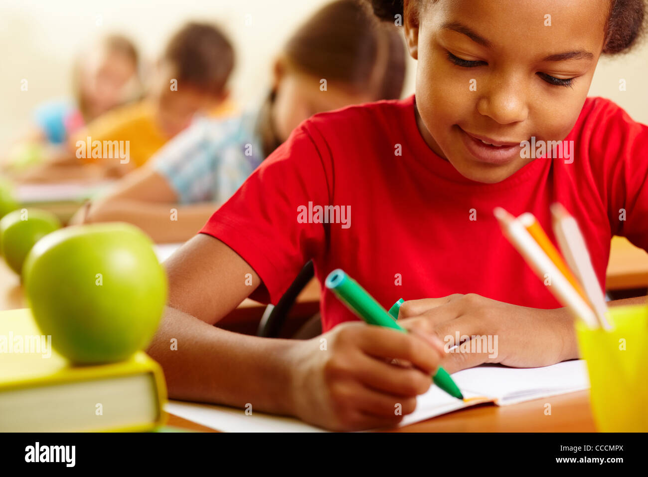 Portrait of lovely girl drawing with crayons at lesson Stock Photo - Alamy