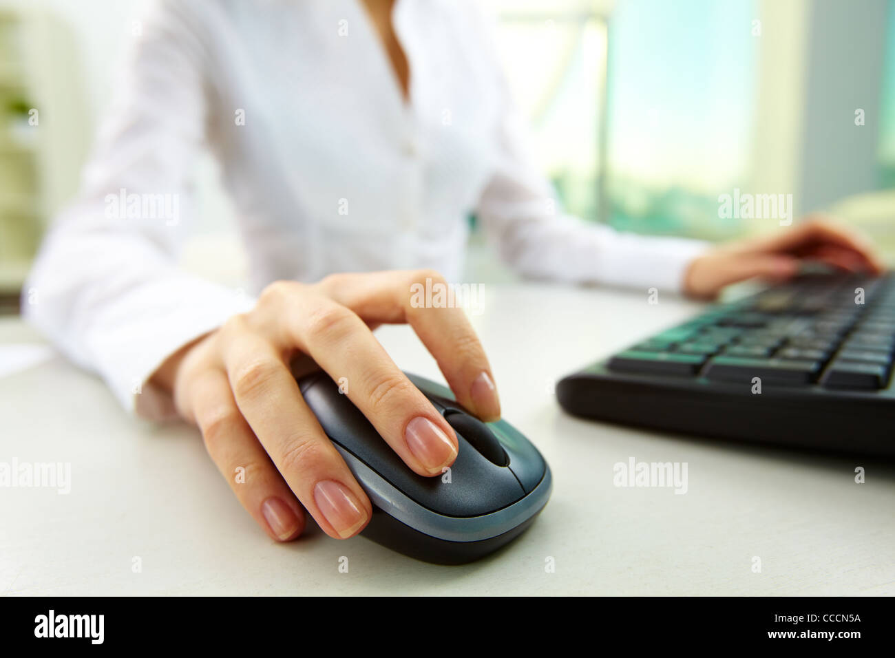 Image of female hands pushing keys of a computer mouse and keyboard ...