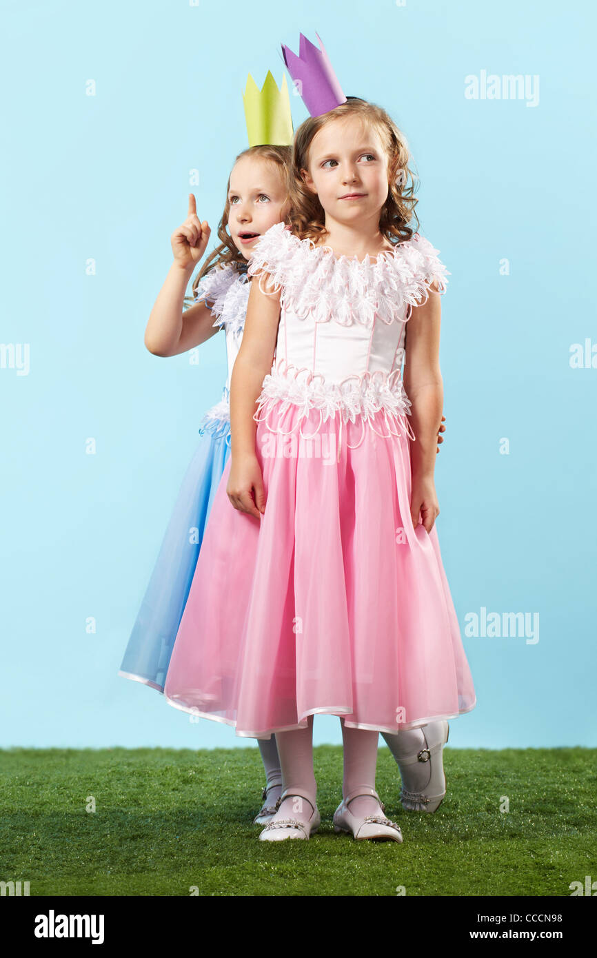 Portrait of two smart girls in beautiful dresses and crowns Stock Photo ...