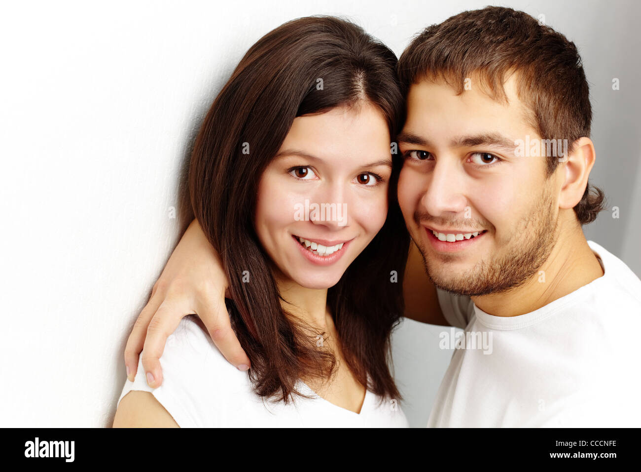 Happy girl and her boyfriend looking at camera Stock Photo - Alamy