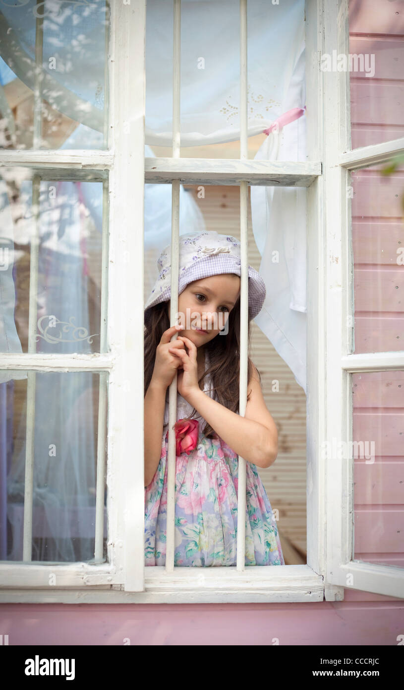 Sweet little girl on the window Stock Photo - Alamy