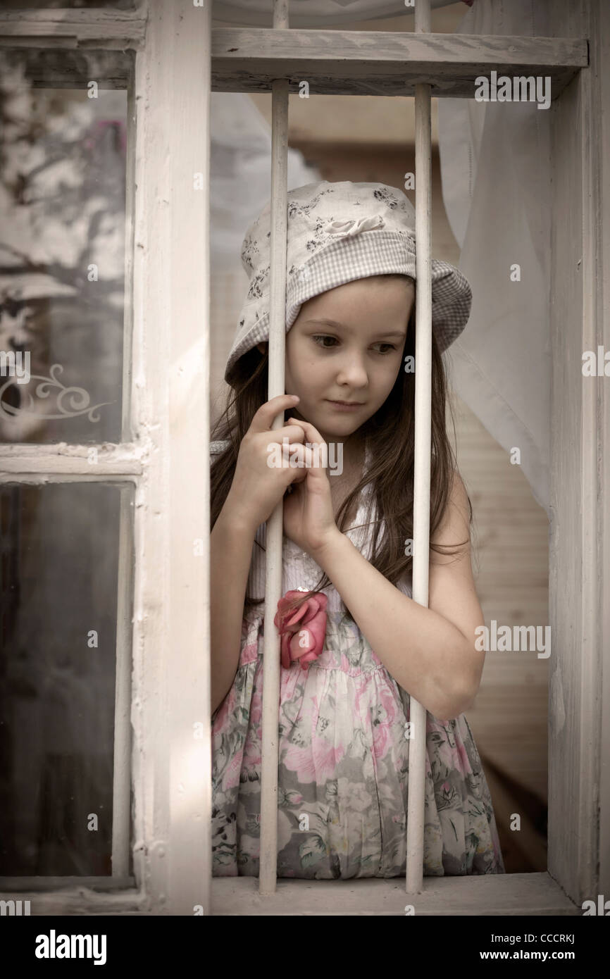 Sweet little girl on the window Stock Photo - Alamy