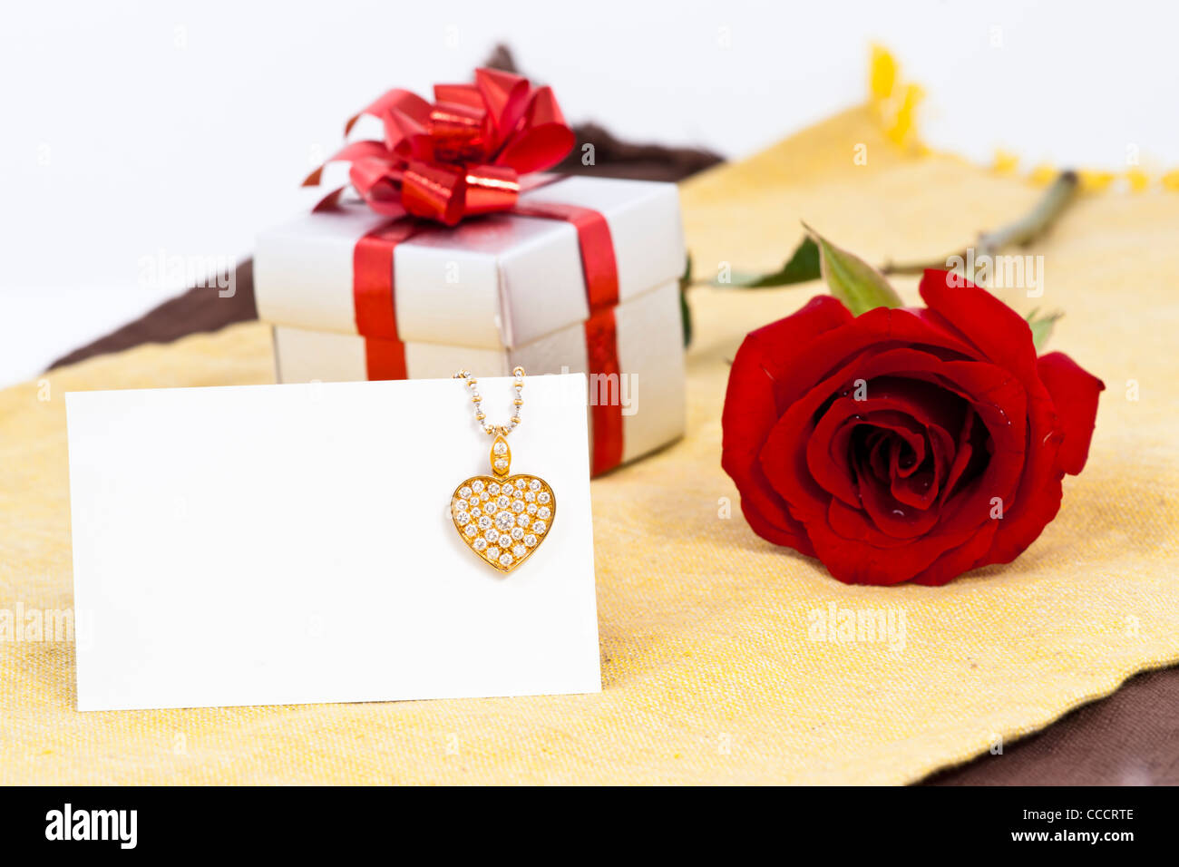 Diamond heart shape pendant and red rose Stock Photo - Alamy