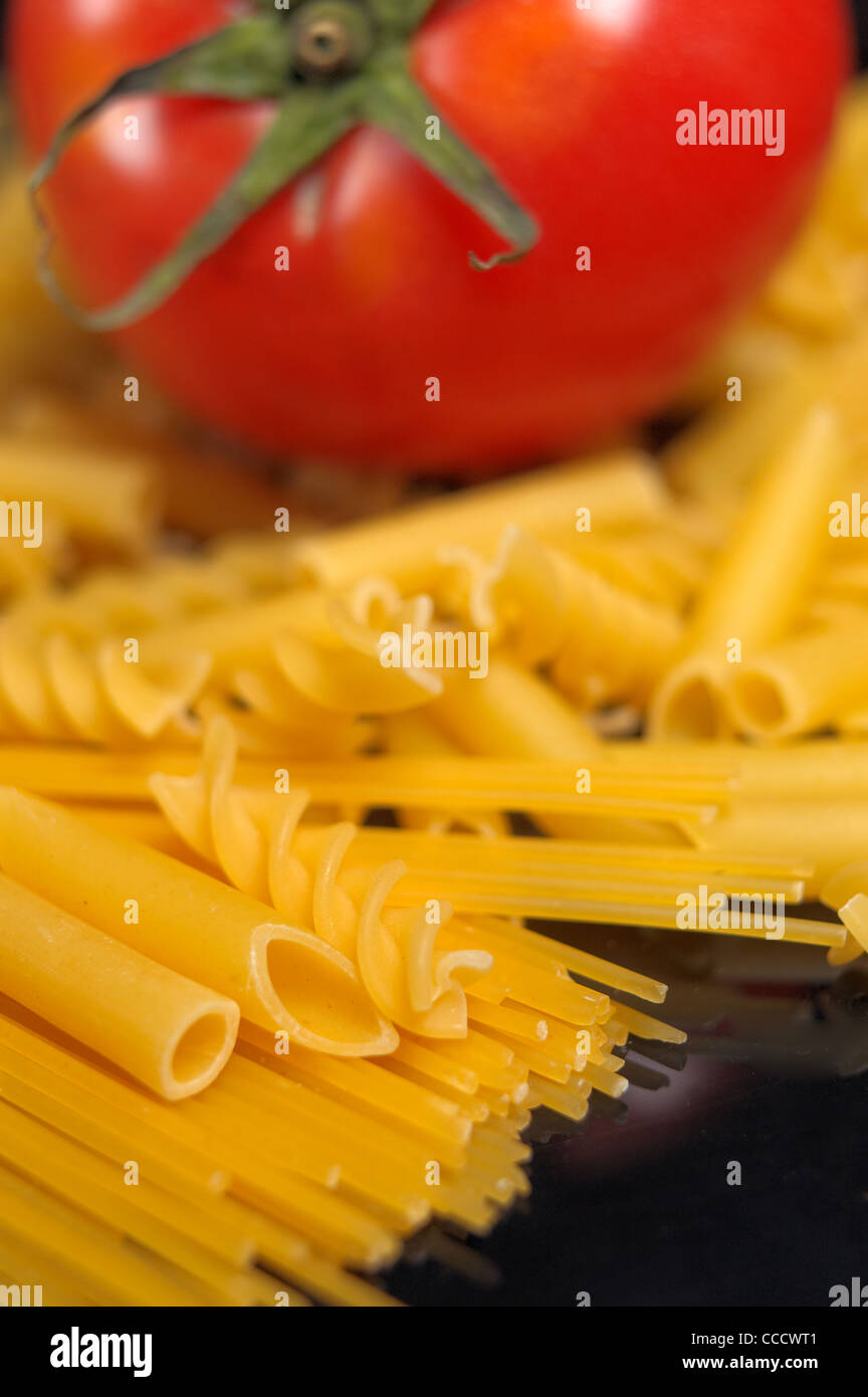 Italian pasta selection with fresh tomato over black closeup DOF Stock ...