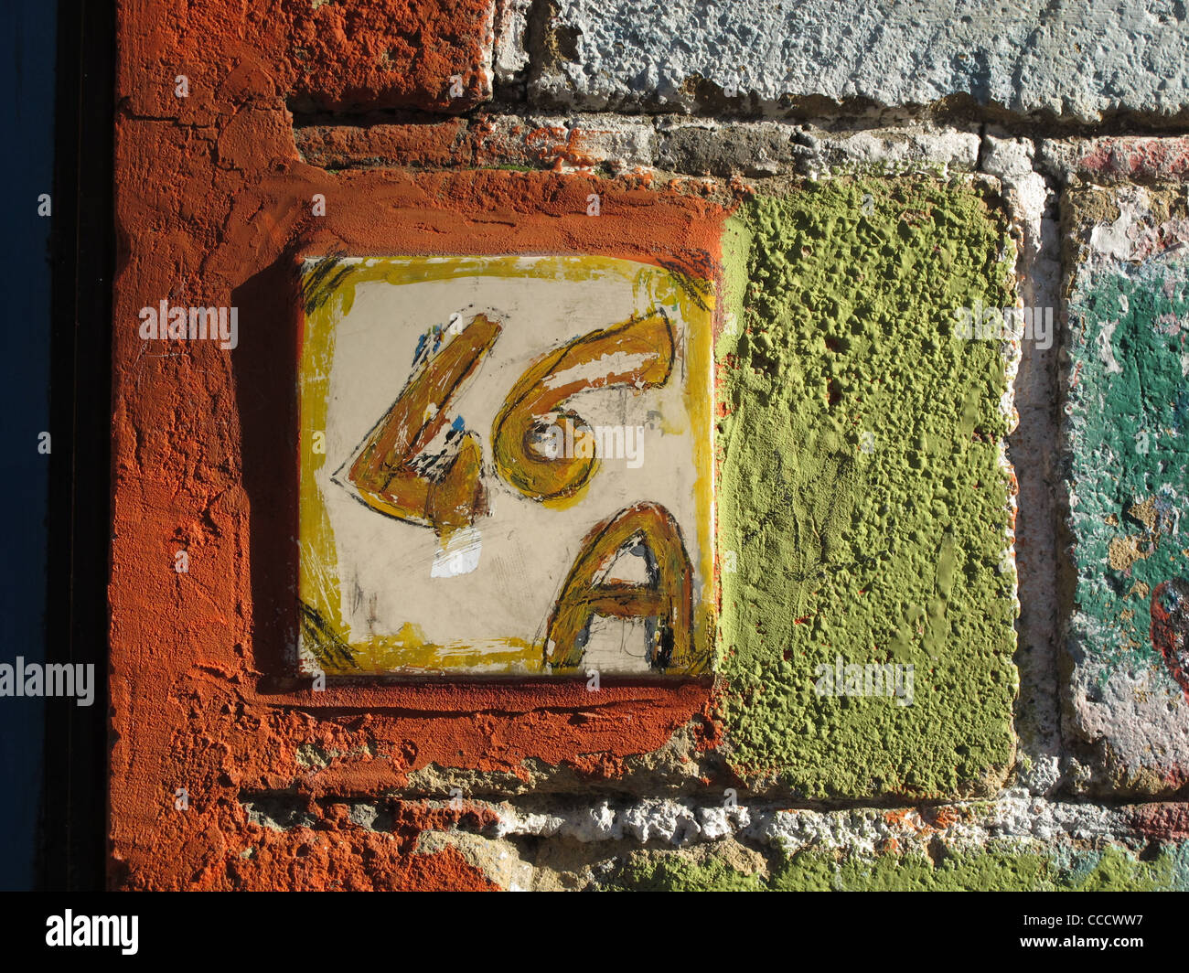 house home street number 46 a name plate design on brick wall in sun ...