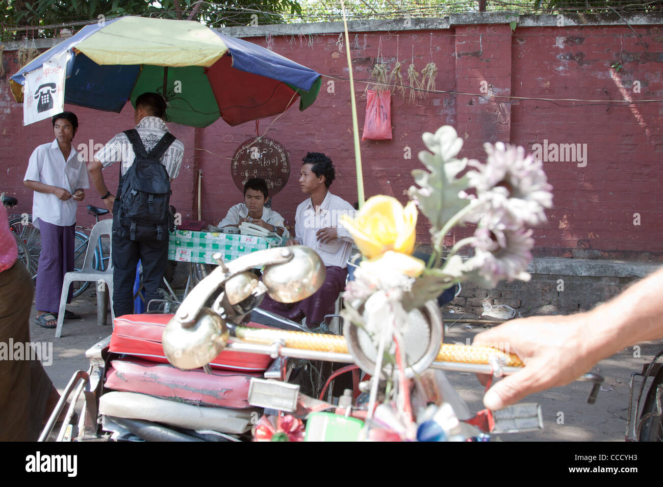 Man is calling from improvised phone booth/box on the street market ...
