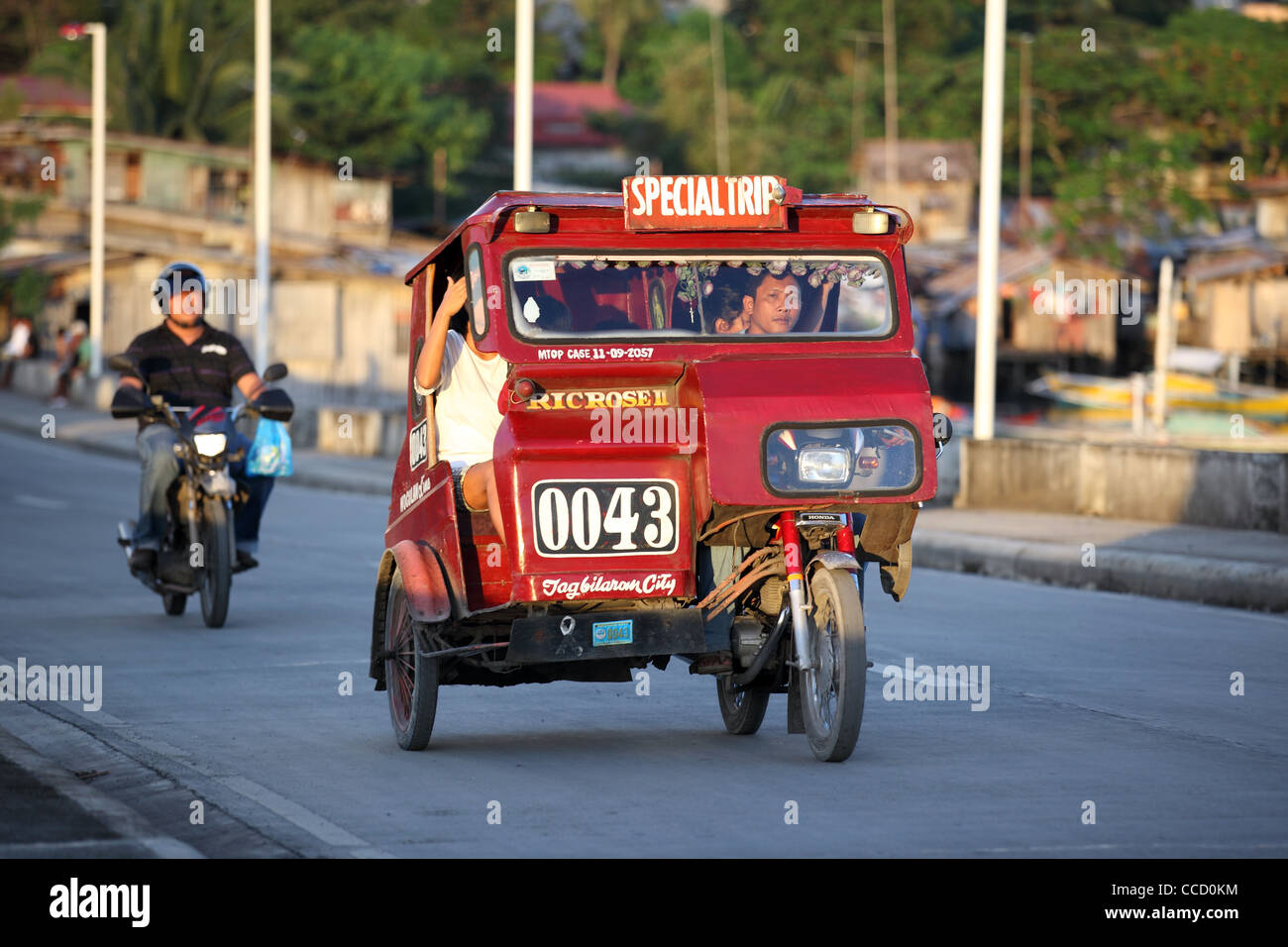Covered motor taxi with passengers crossing bridge. Panglao Island ...