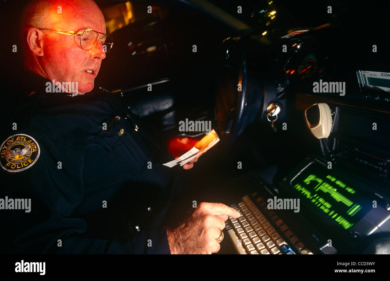 A police officer from the City of Atlanta checks the identity of a ...