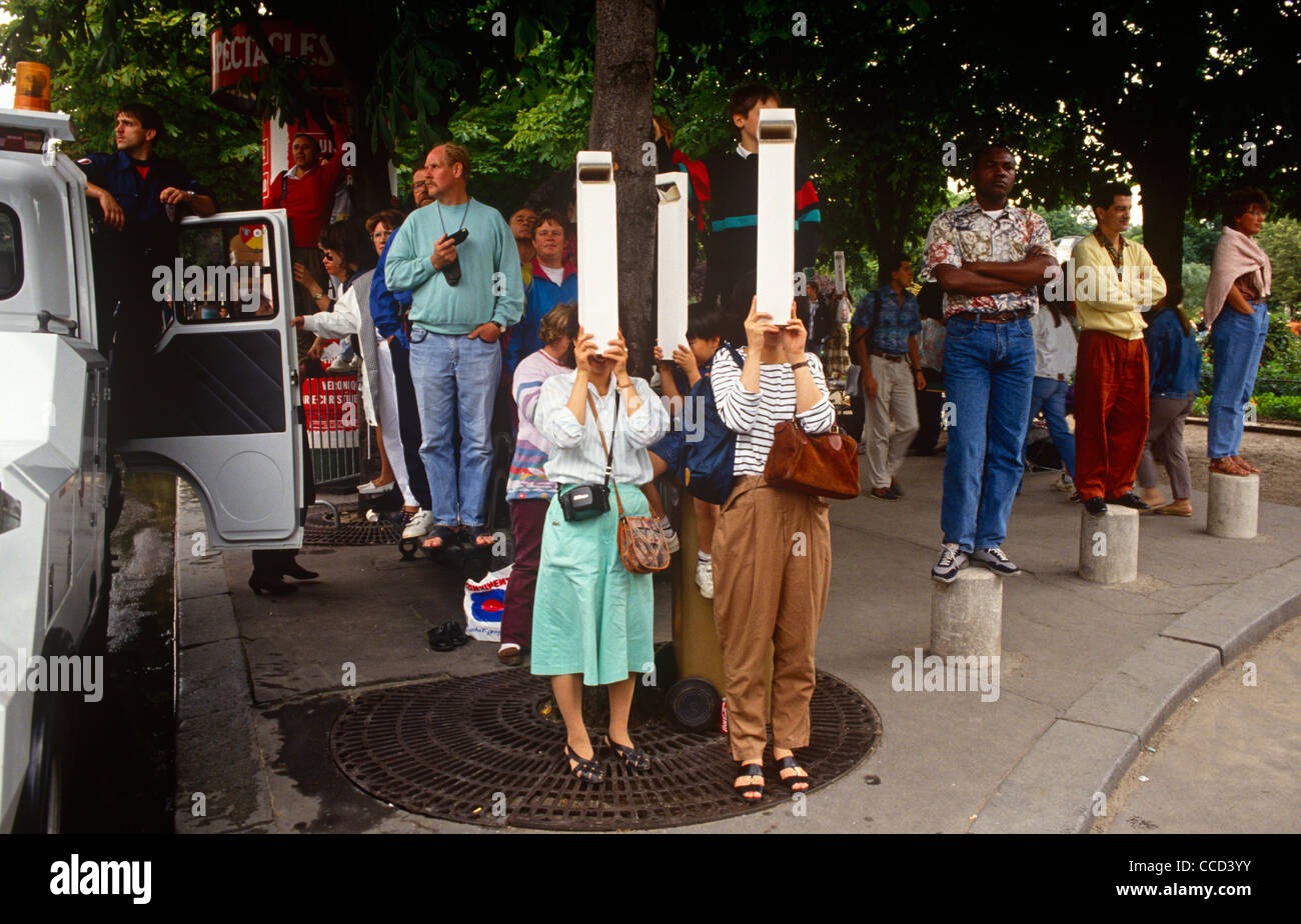 Sightseers use periscopes to watch parade during the annual Bastille ...