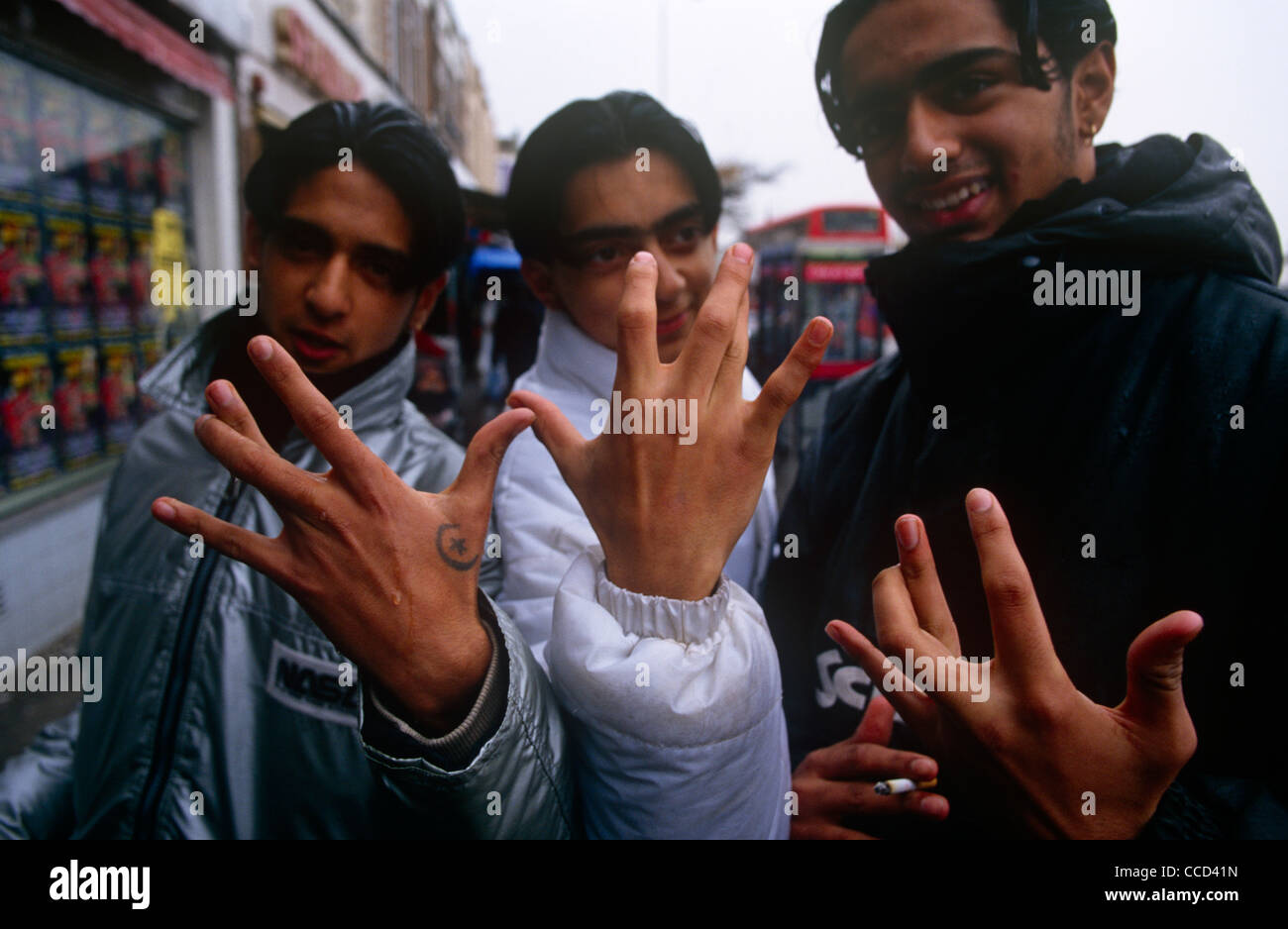 Three young British Asians pose in the street to show their gangland ...