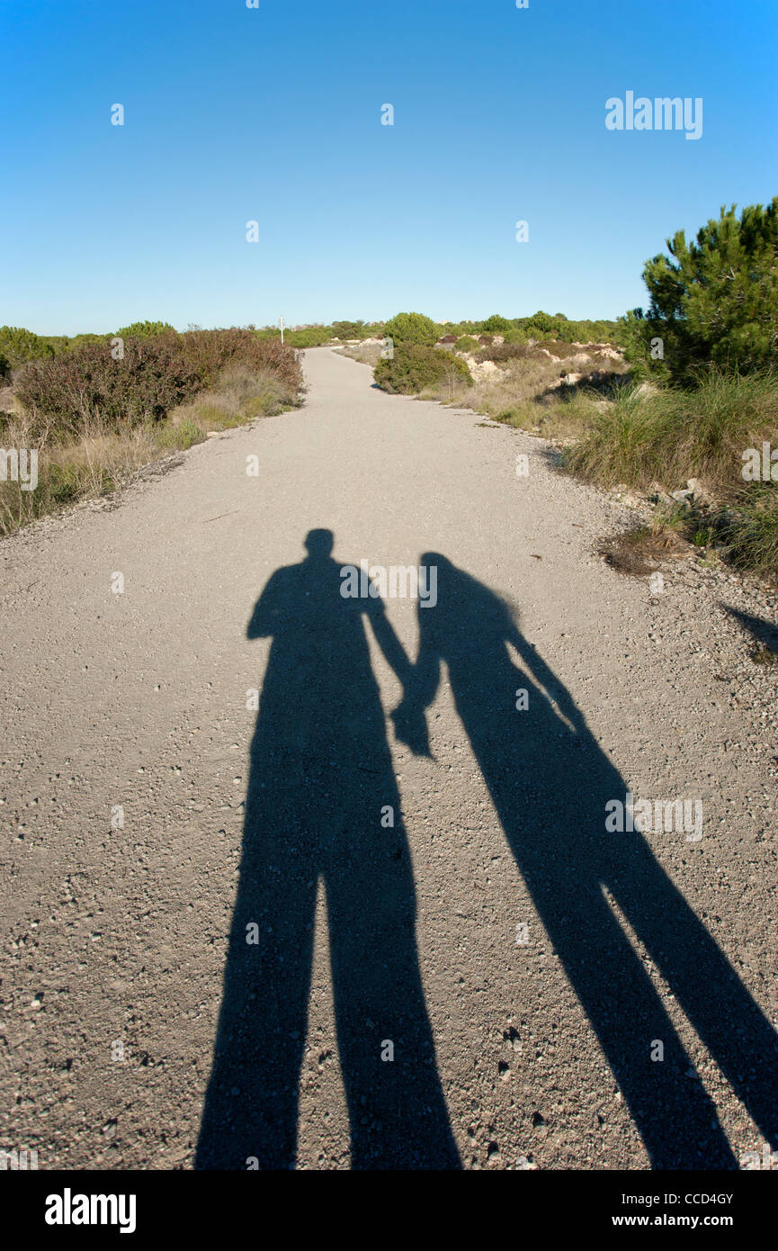 Two shadows holding hands, a love concept Stock Photo - Alamy