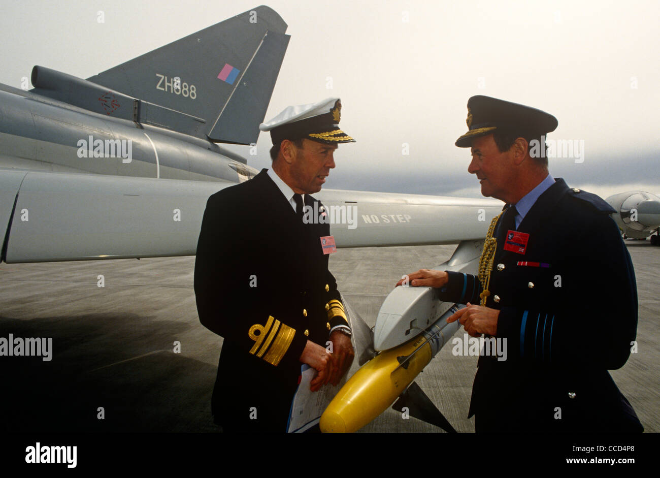 A Royal Navy Admiral and an RAF Air Chief Marshal inspect a missile of ...