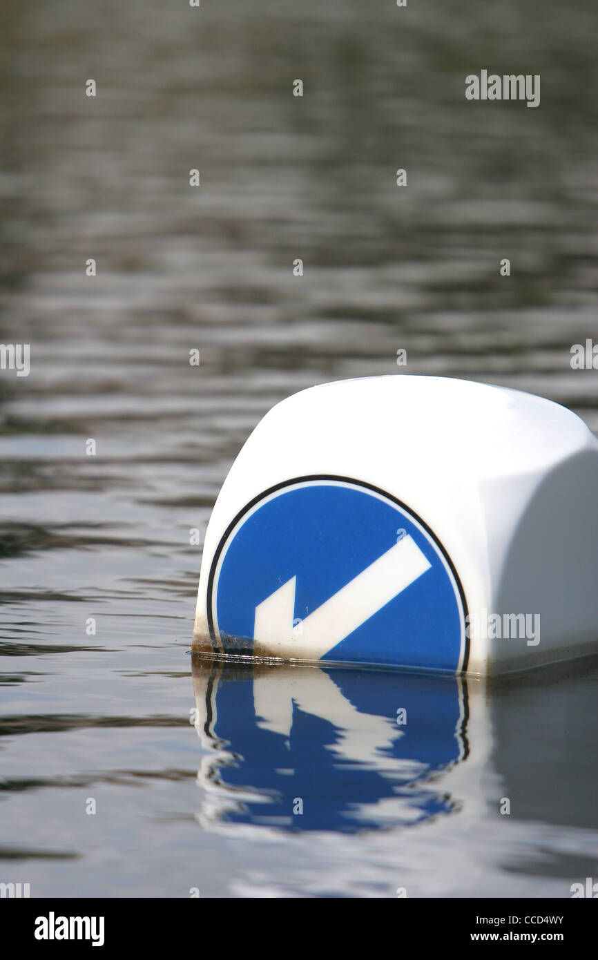 flooding obscuring road sign bollard after heavy rains UK Stock Photo ...