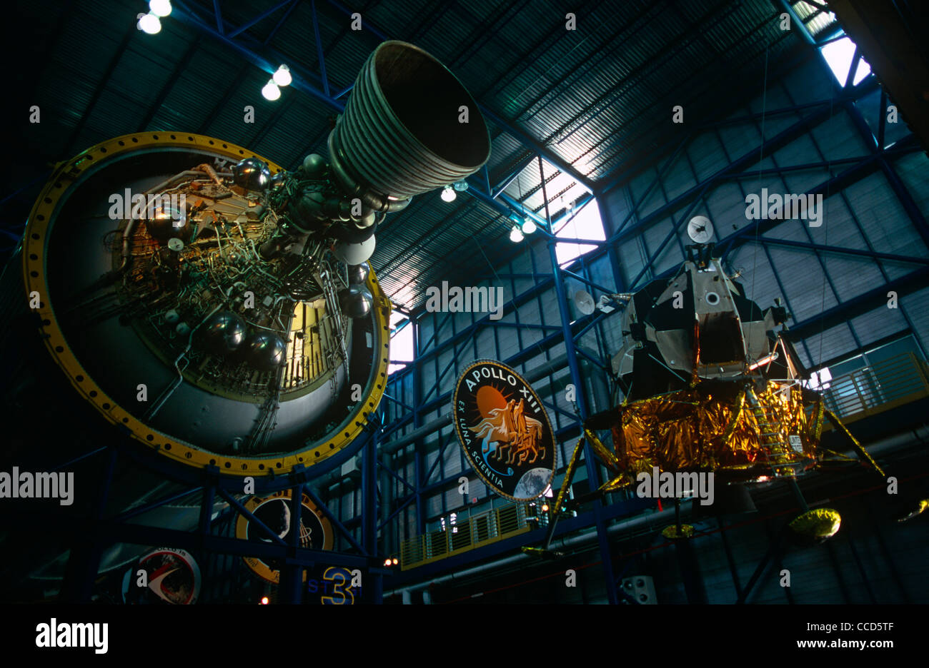 Suspended above the heads of space tourists are an Apollo rocket stage ...