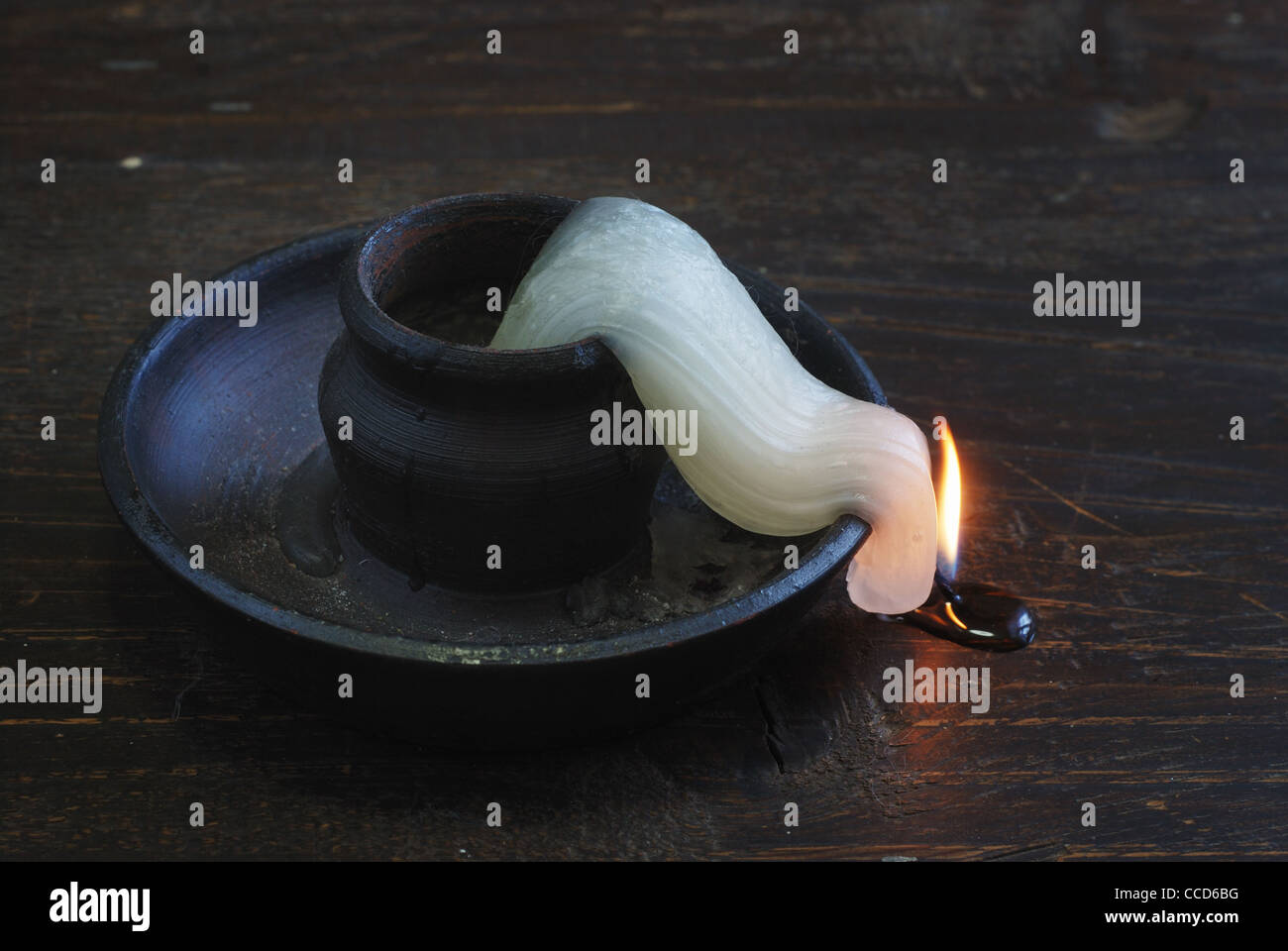 deformed candle-end in an old ceramic candlestick Stock Photo - Alamy