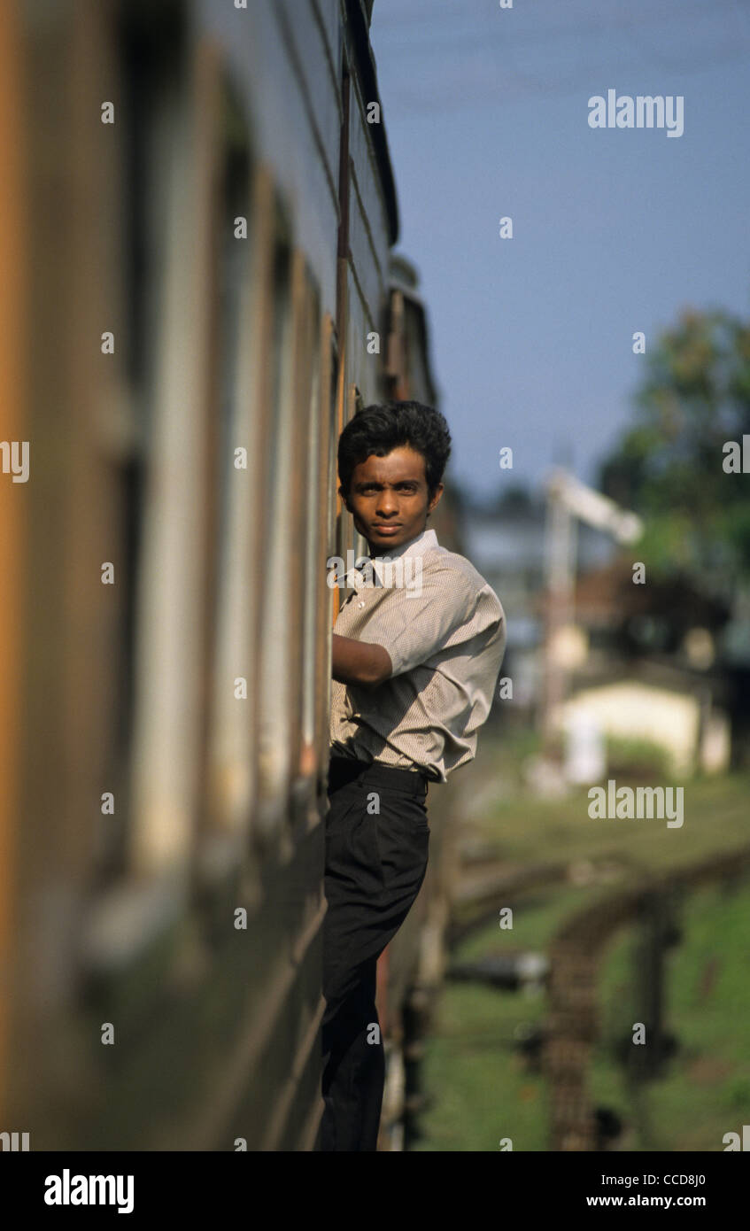 Young local man passenger hanging outside, Train Intercity Express ...