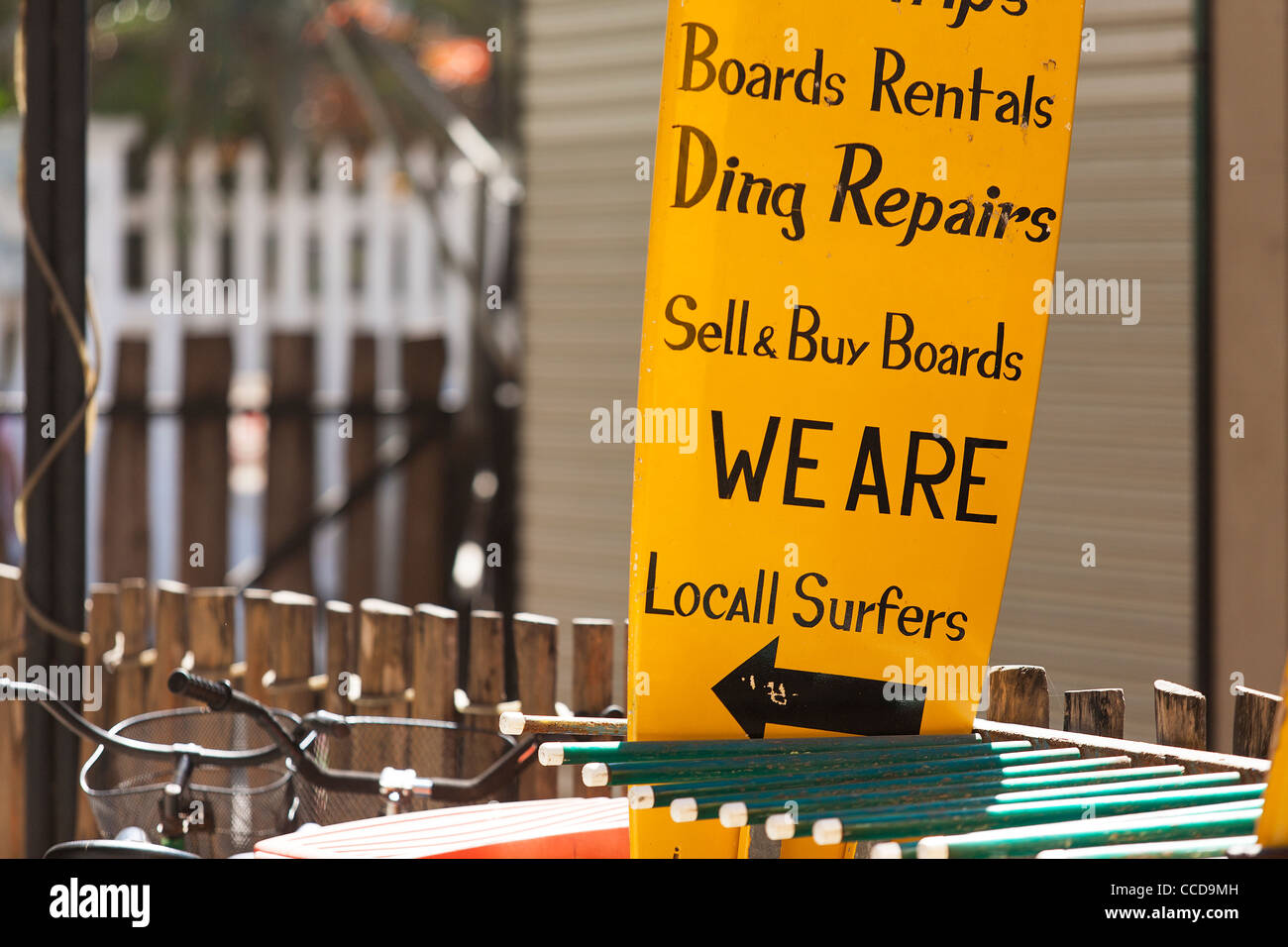 A sign painted on a surfboard advertising surf lessons in Tamarindo ...
