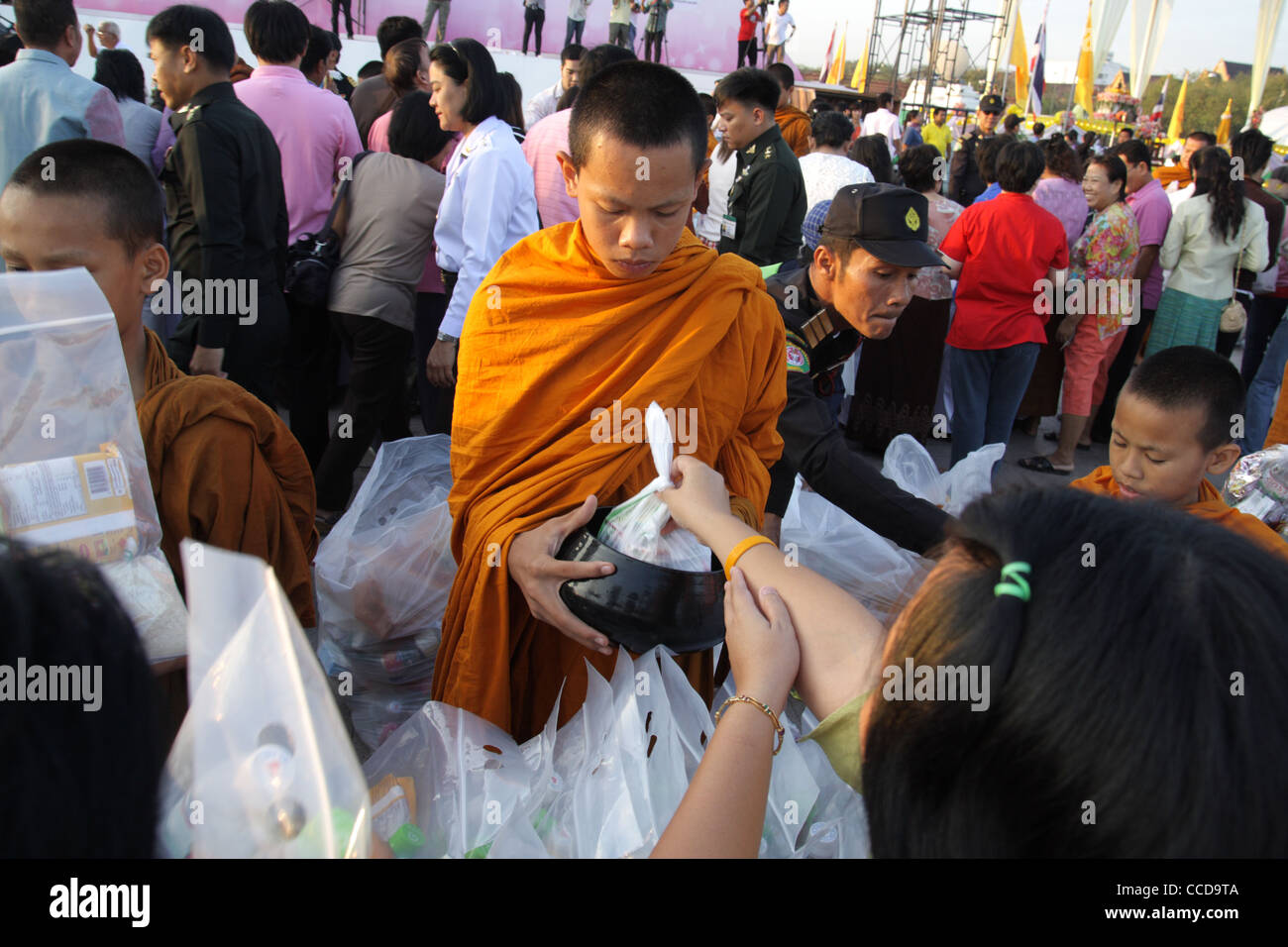 Thai people make offerings to Buddhist monks , Bangkok Stock Photo - Alamy