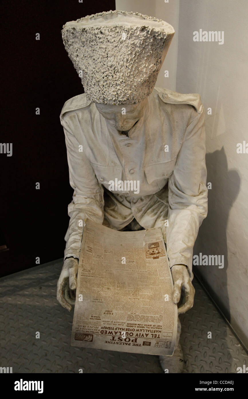 Sculpted figure of a prison guardian reading The Palestine Post ...