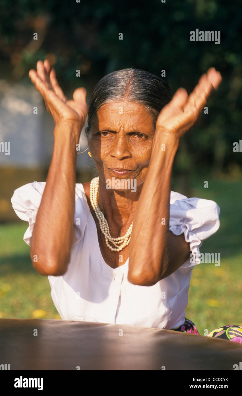 Old lady playing drum with hands, Dambulla, Sri Lanka Stock Photo - Alamy